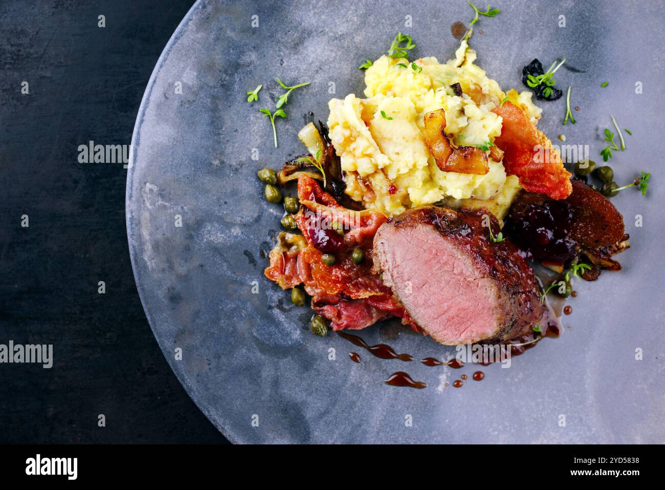 Traditional fried wild hare back filet with plums Stock Photo - Alamy