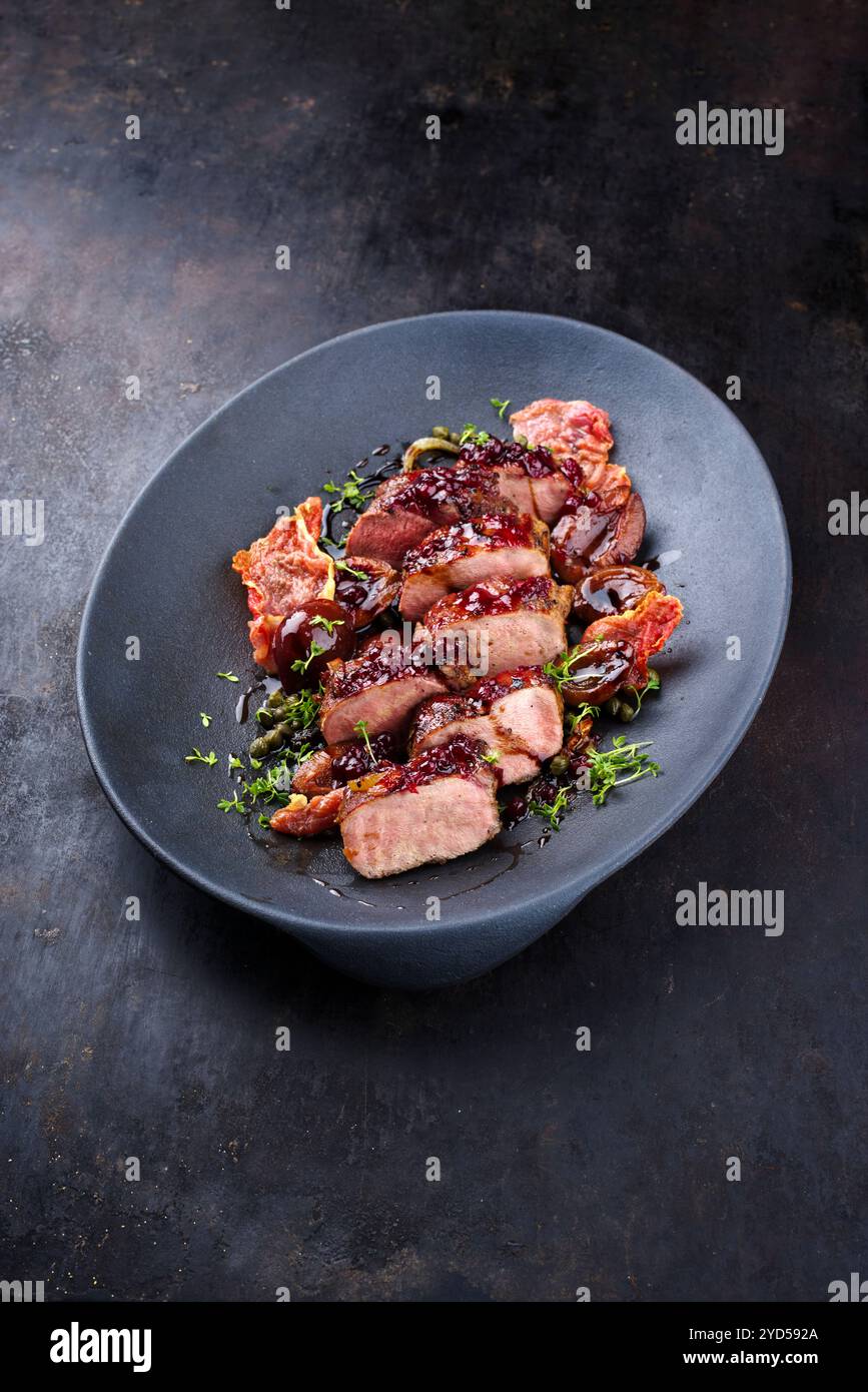 Traditional fried wild hare back filet with plums Stock Photo - Alamy