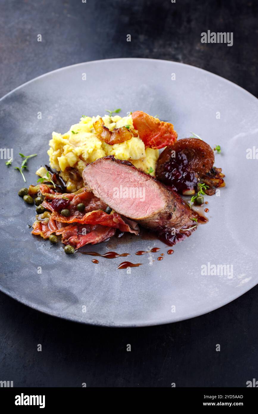 Traditional fried wild hare back filet with plums Stock Photo - Alamy