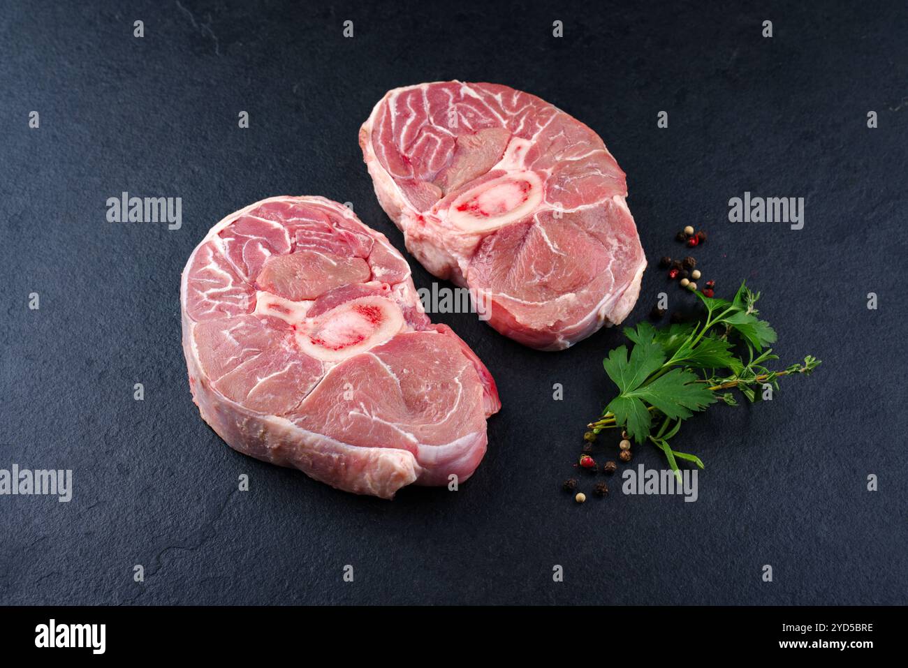 Raw beef leg slice with cross-section marbling as ossobuco offered with ...