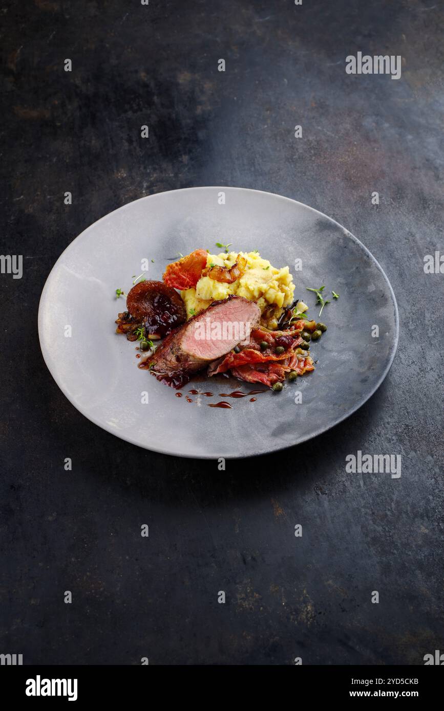 Traditional fried wild hare back filet with plums Stock Photo - Alamy