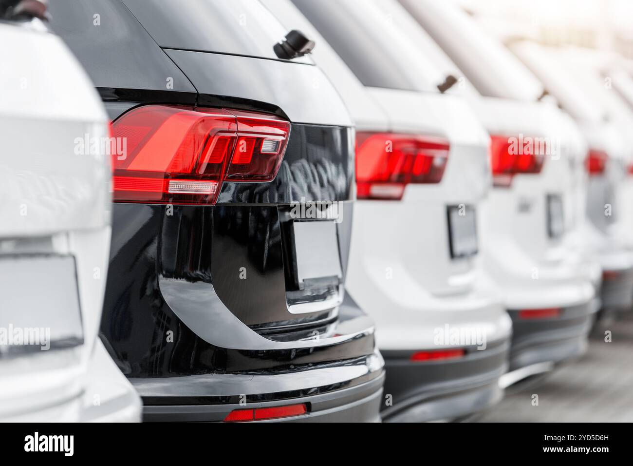 Back view many modern new SUV cars fleet stock at dealership parking ...