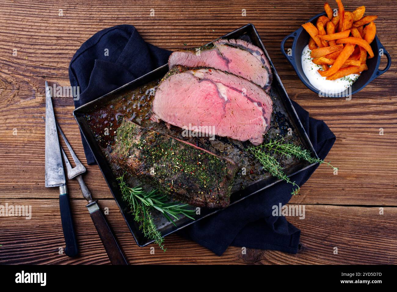 Traditional Commonwealth Sunday roast beef sliced with herbs and served ...