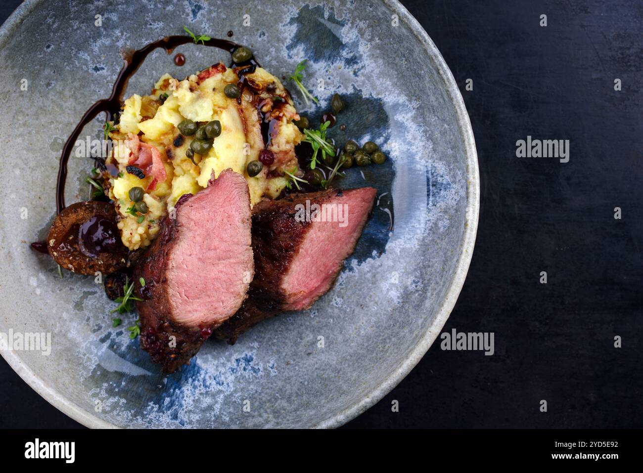 Traditional fried wild hare back filet with plums Stock Photo - Alamy