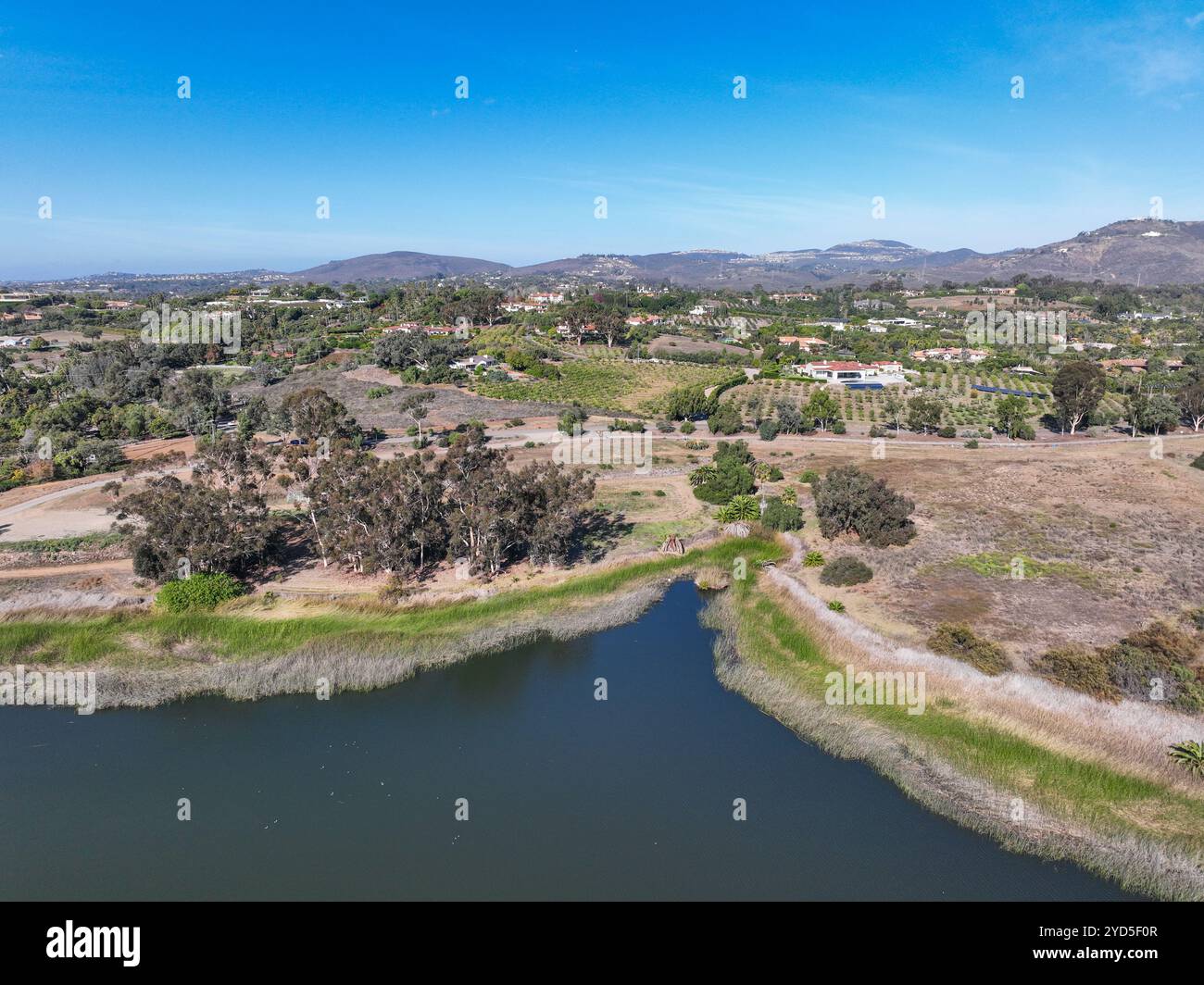 Aerial view over water reservoir and a large dam that holds water ...