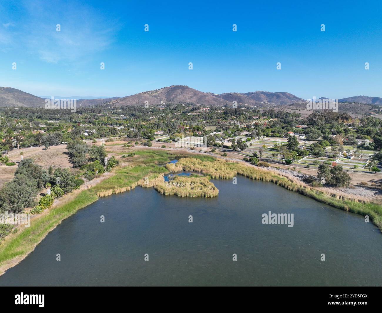 Aerial view over water reservoir and a large dam that holds water ...