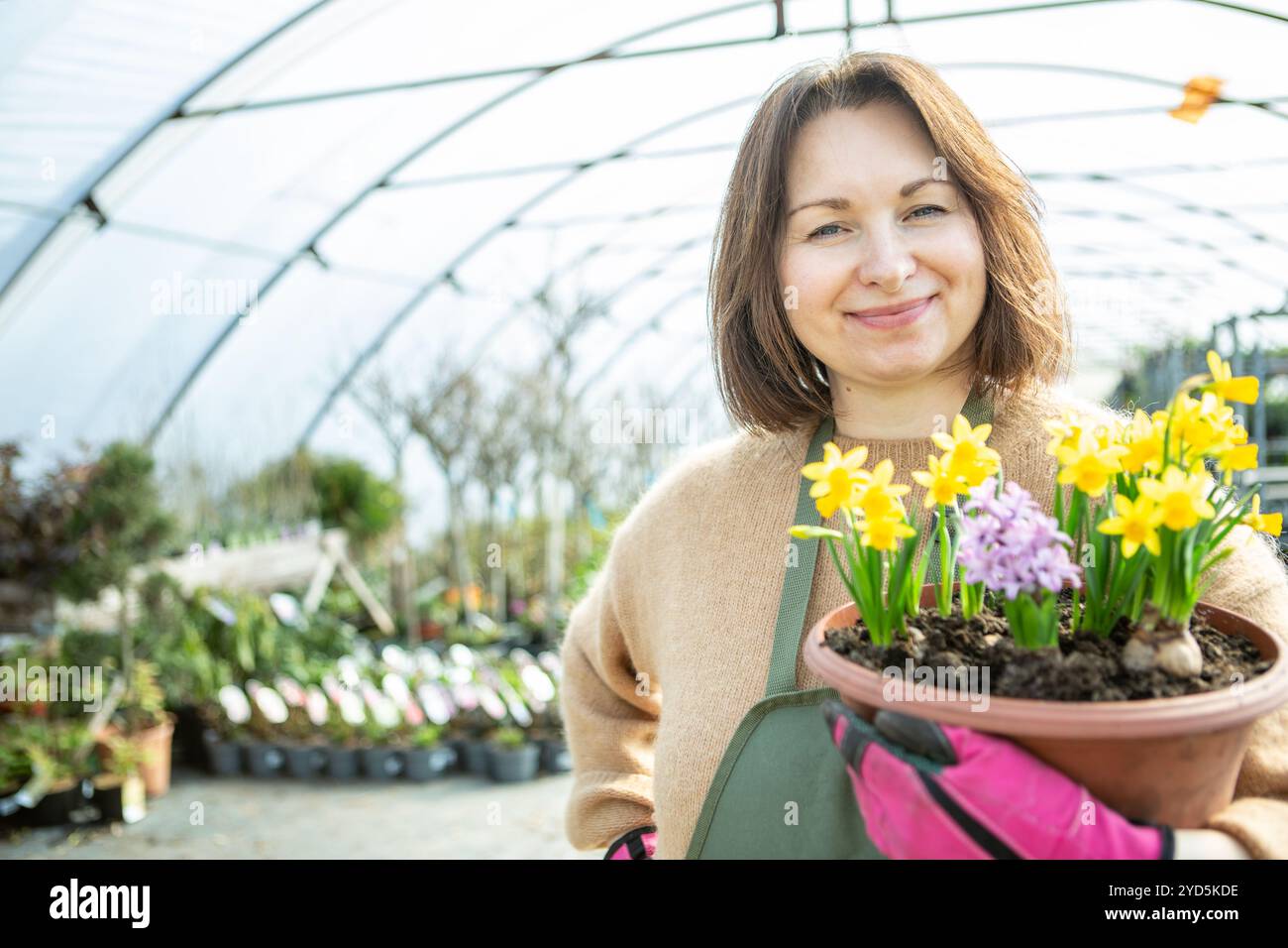 Gardener with flowers Stock Photo - Alamy