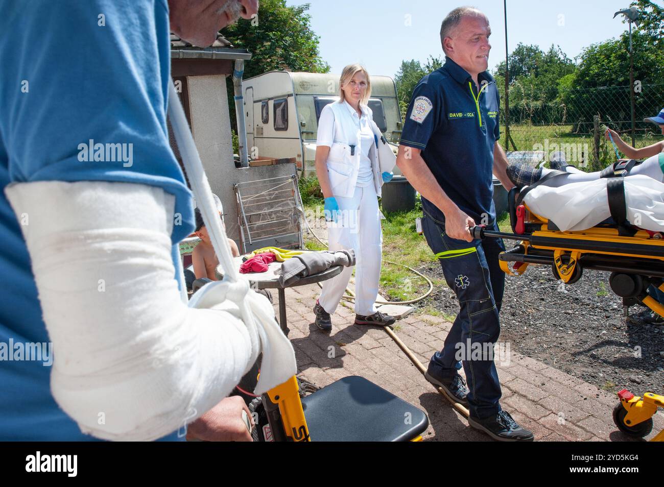 A medical emergency with a person injured and receiving treatment Stock ...