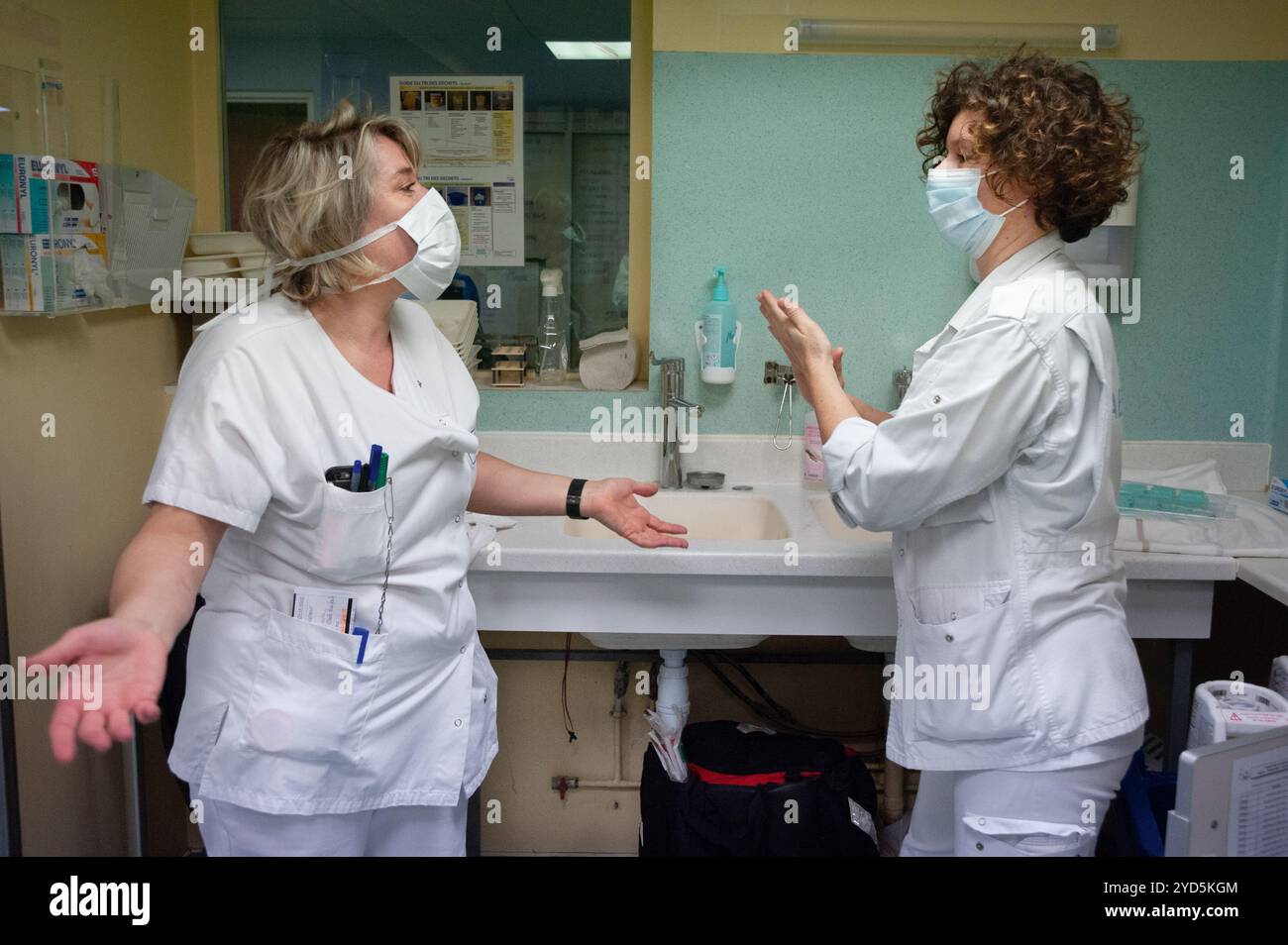 Two medical professionals washing hands together in a clinical setting ...
