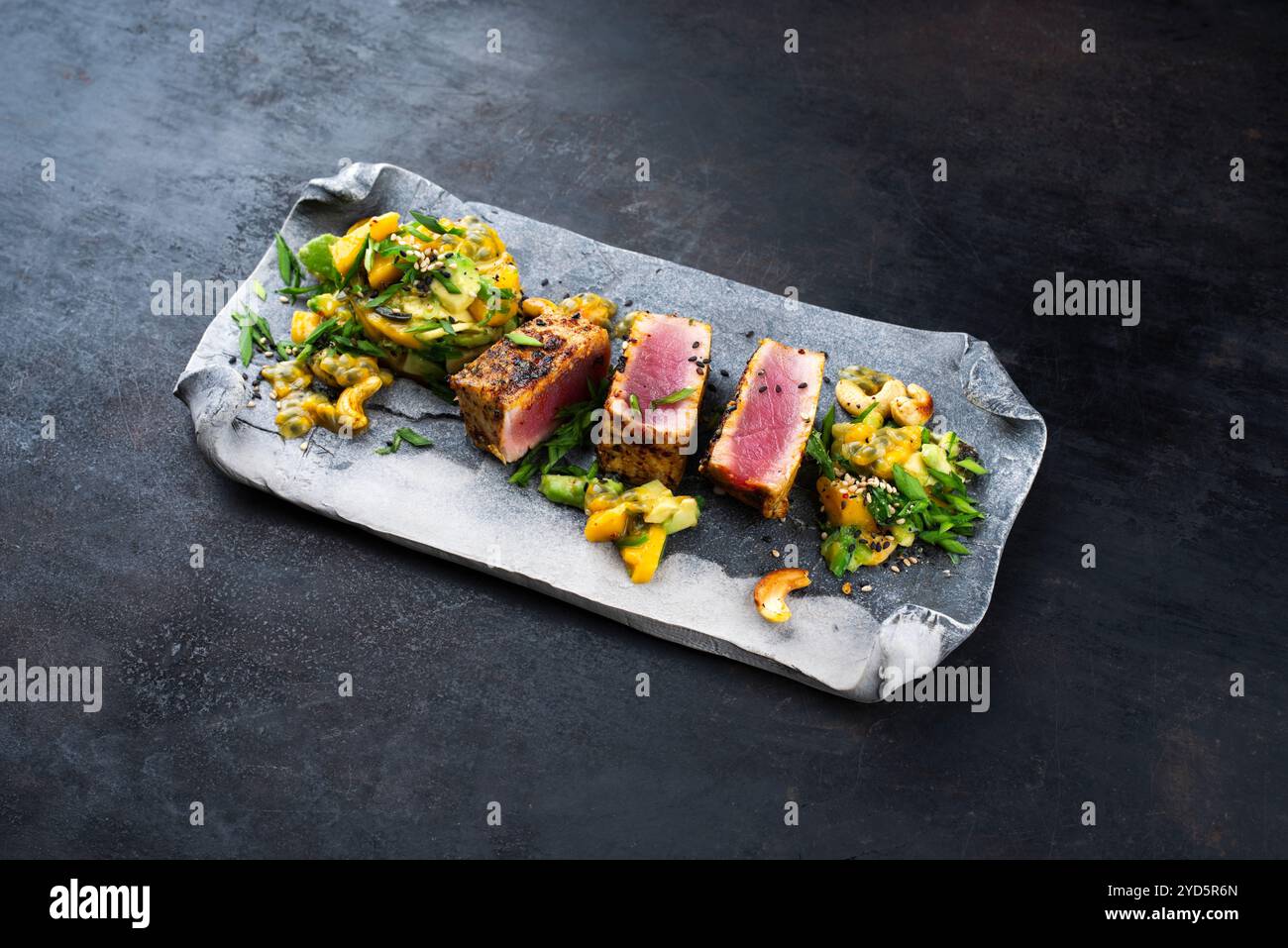 Traditional Japanese gourmet tuna fish steak tataki with tropical fruit ...