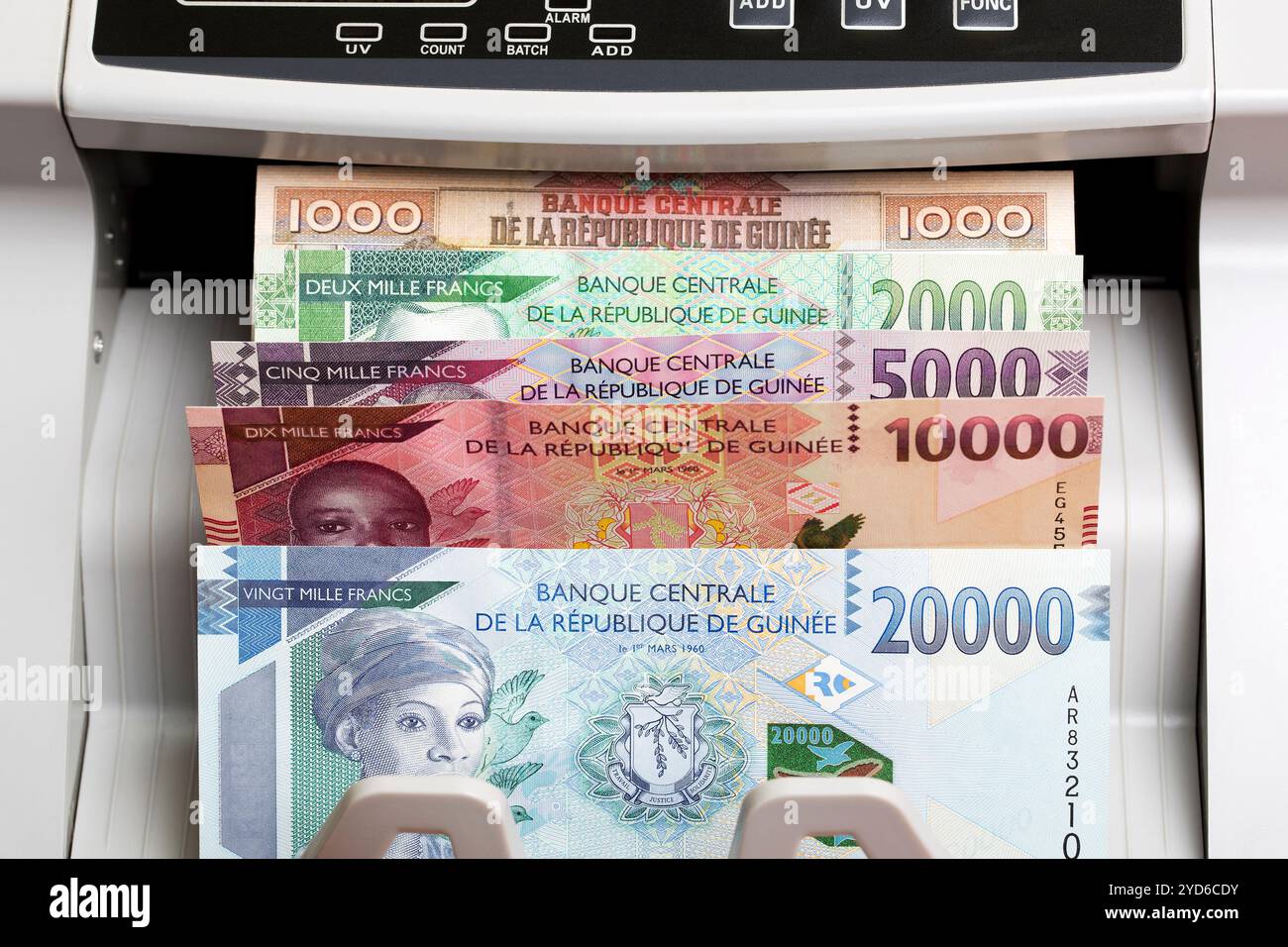 Guinean franc in a counting machine Stock Photo - Alamy