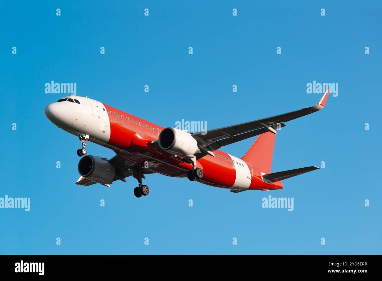 Passenger red and white colours airplane landing gear flying in the ...