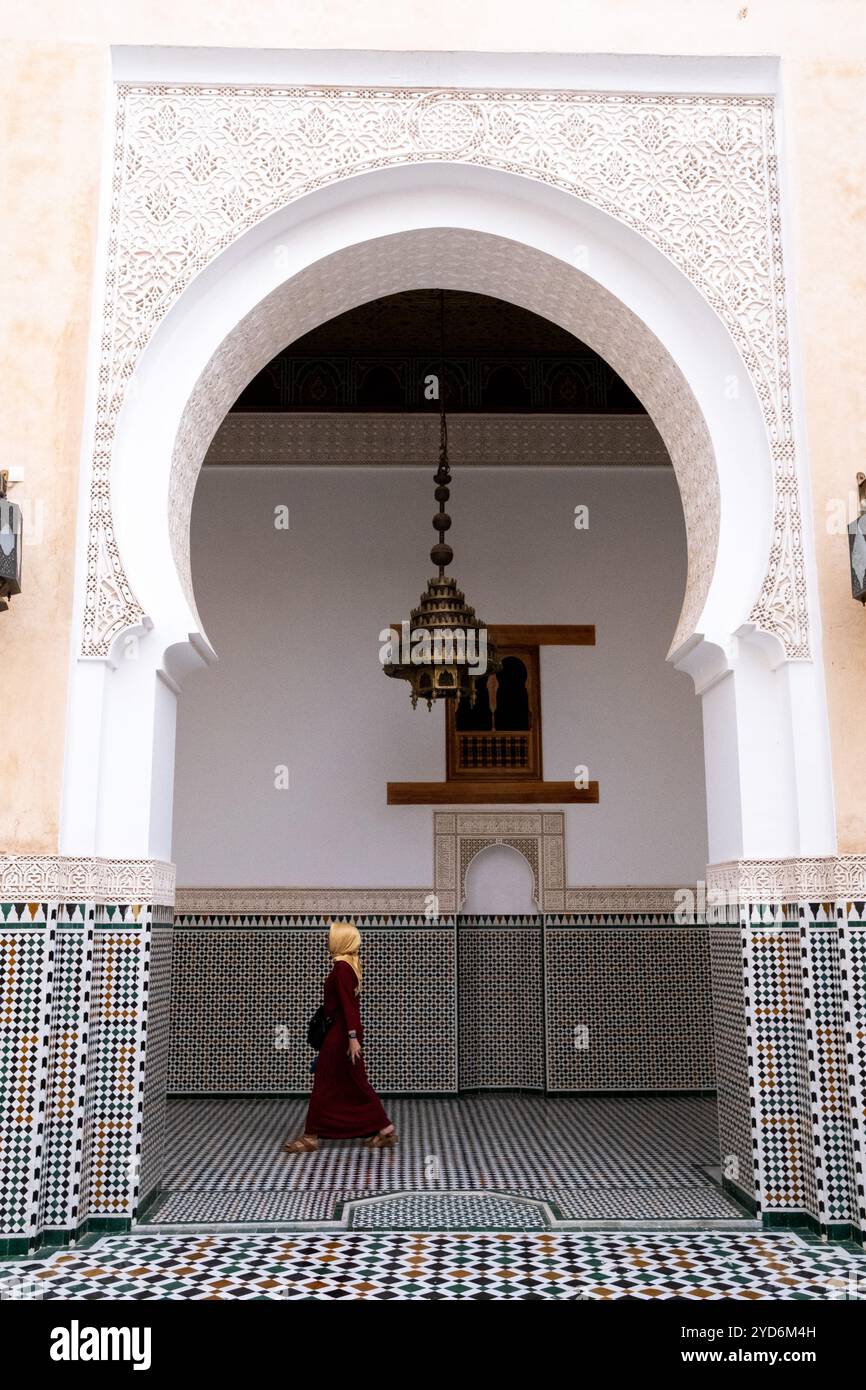 Veiled woman in the interior of the mausoleum of Moulay Ismail with ...