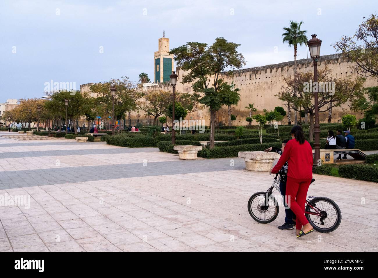Mother and child playing in the square of Place Lalla Aouda in the city ...