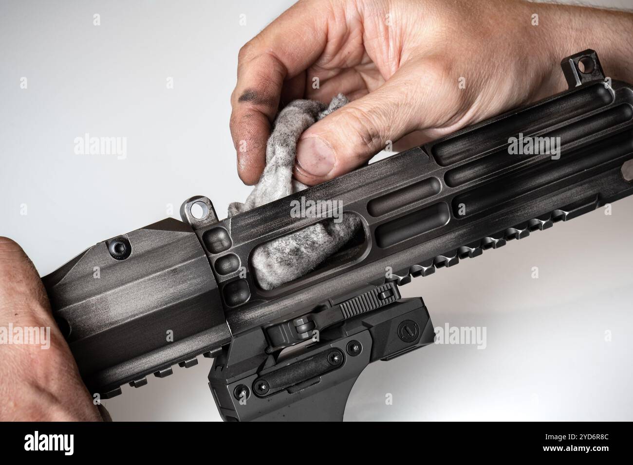 Man`s hands holding rifle parts details and cleaning the gun Stock ...