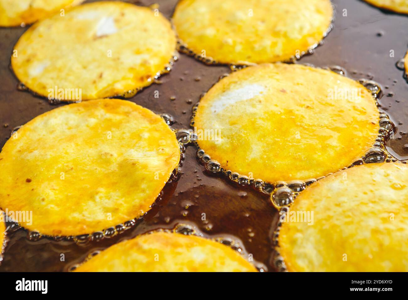 Tacos tortillas preparation on griddle in professional kitchen in ...