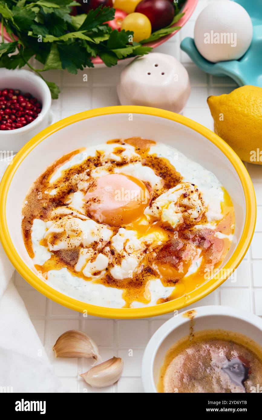 Cilbir or Turkish Eggs in white bowl. . Traditional Turkish breakfast ...