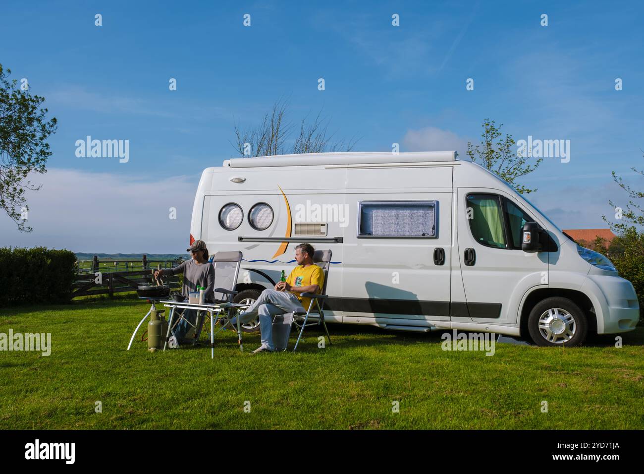 Two individuals enjoying a scenic moment of relaxation outside their ...