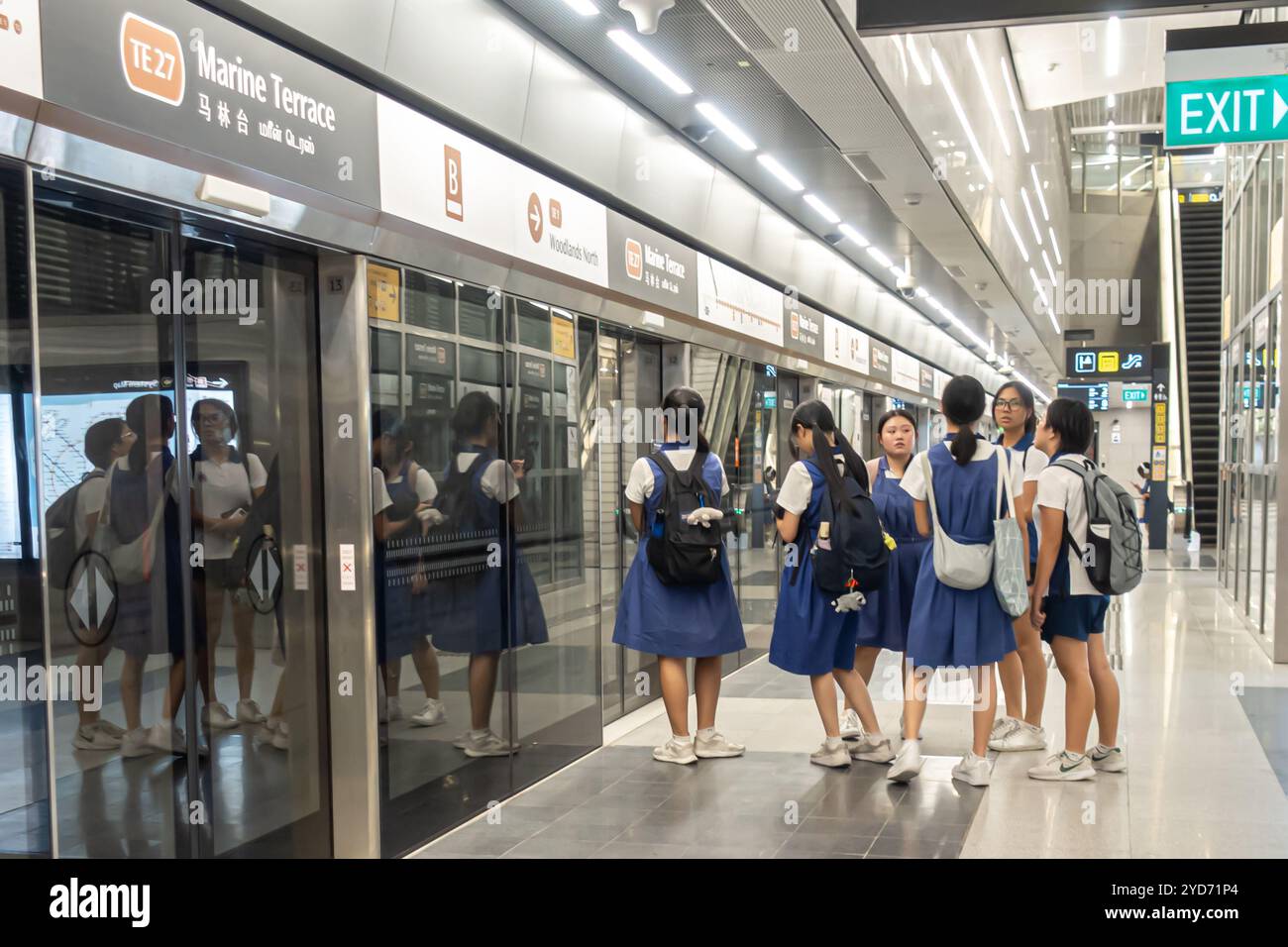 A group of female students classmates on the train platform waiting for ...