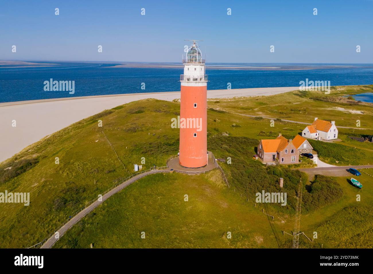 Majestic lighthouse overlooking a sandy beach, standing tall and ...