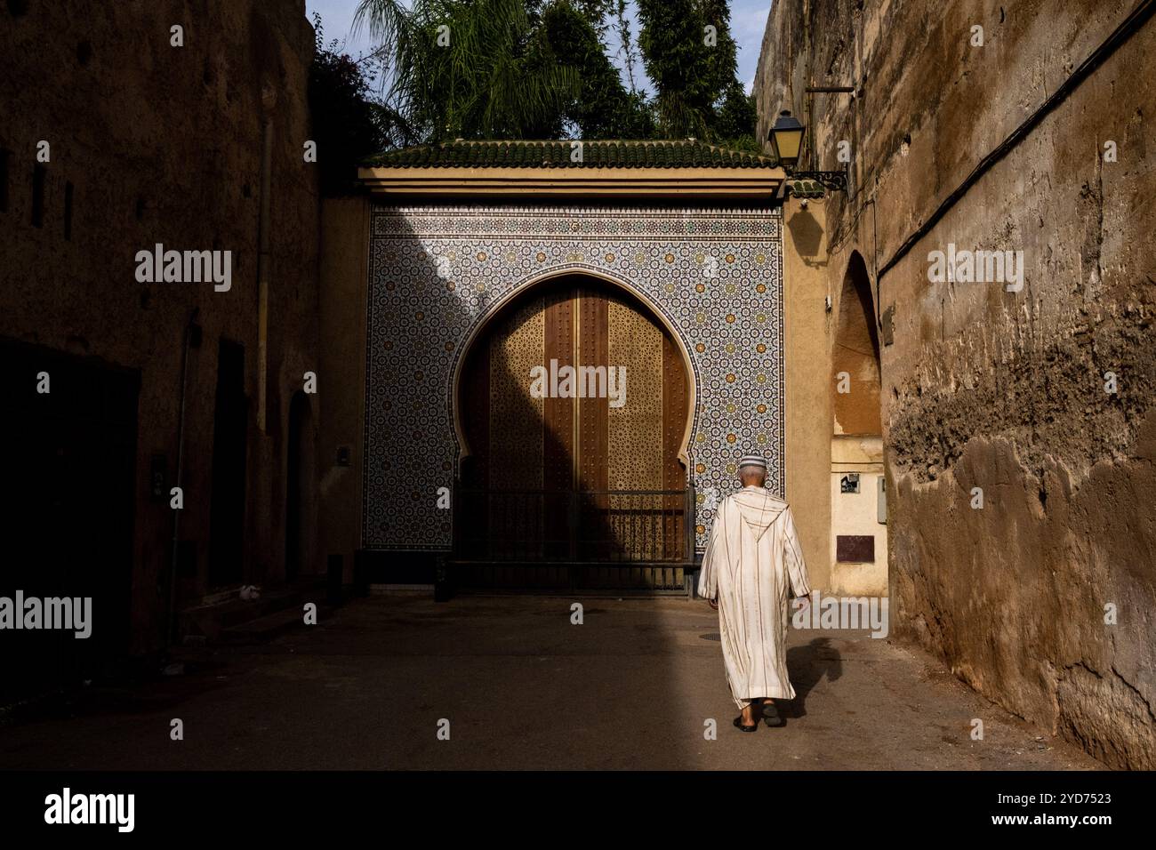 Moroccan man in traditional dress walking in the medina of the city of ...
