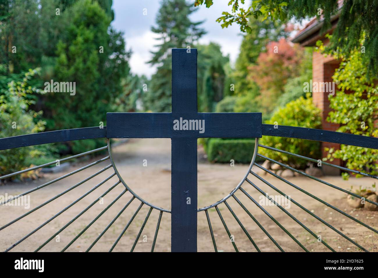 A cross of the entry of a cemetery Stock Photo - Alamy