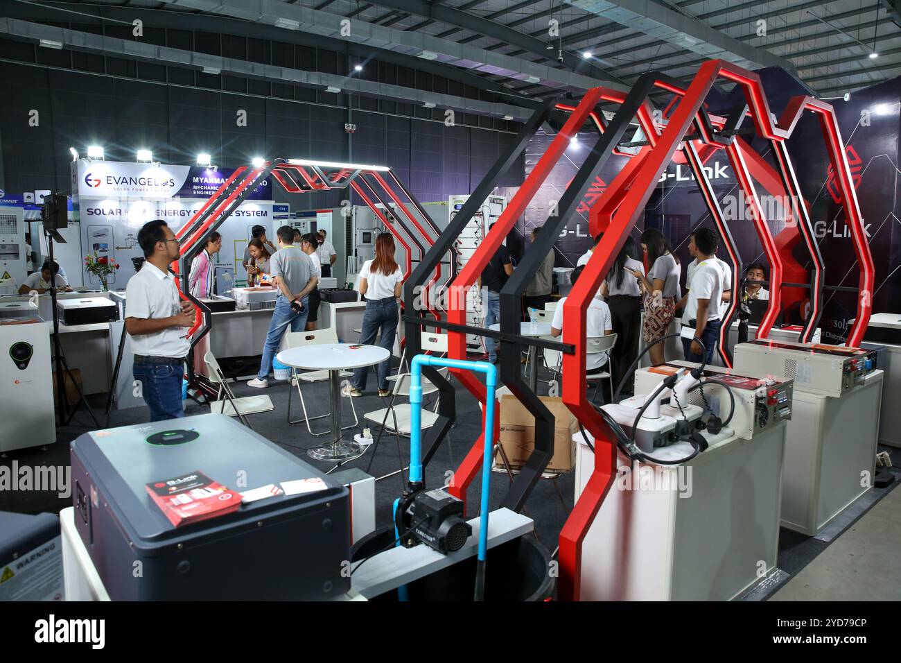 (241025) -- YANGON, Oct. 25, 2024 (Xinhua) -- Staff members work at an exhibition booth during ...