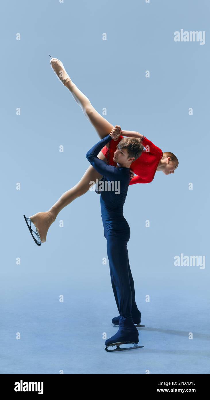 Figure skating couple performing impressive overhead lift against cold ...