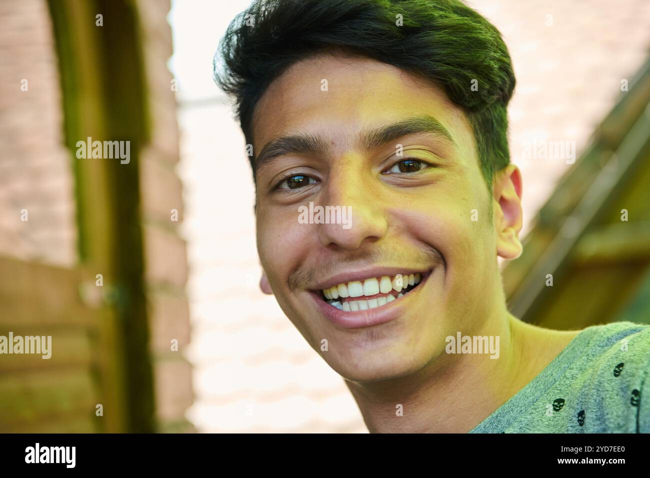 A closeup of a Middle Eastern man with a broad smile and beautiful ...