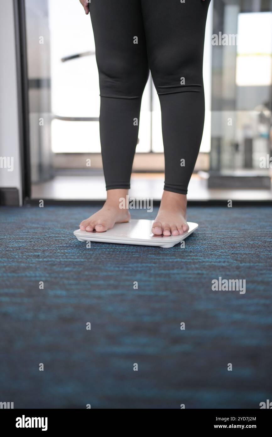 Fat diet and scale feet standing on electronic scales for weight ...