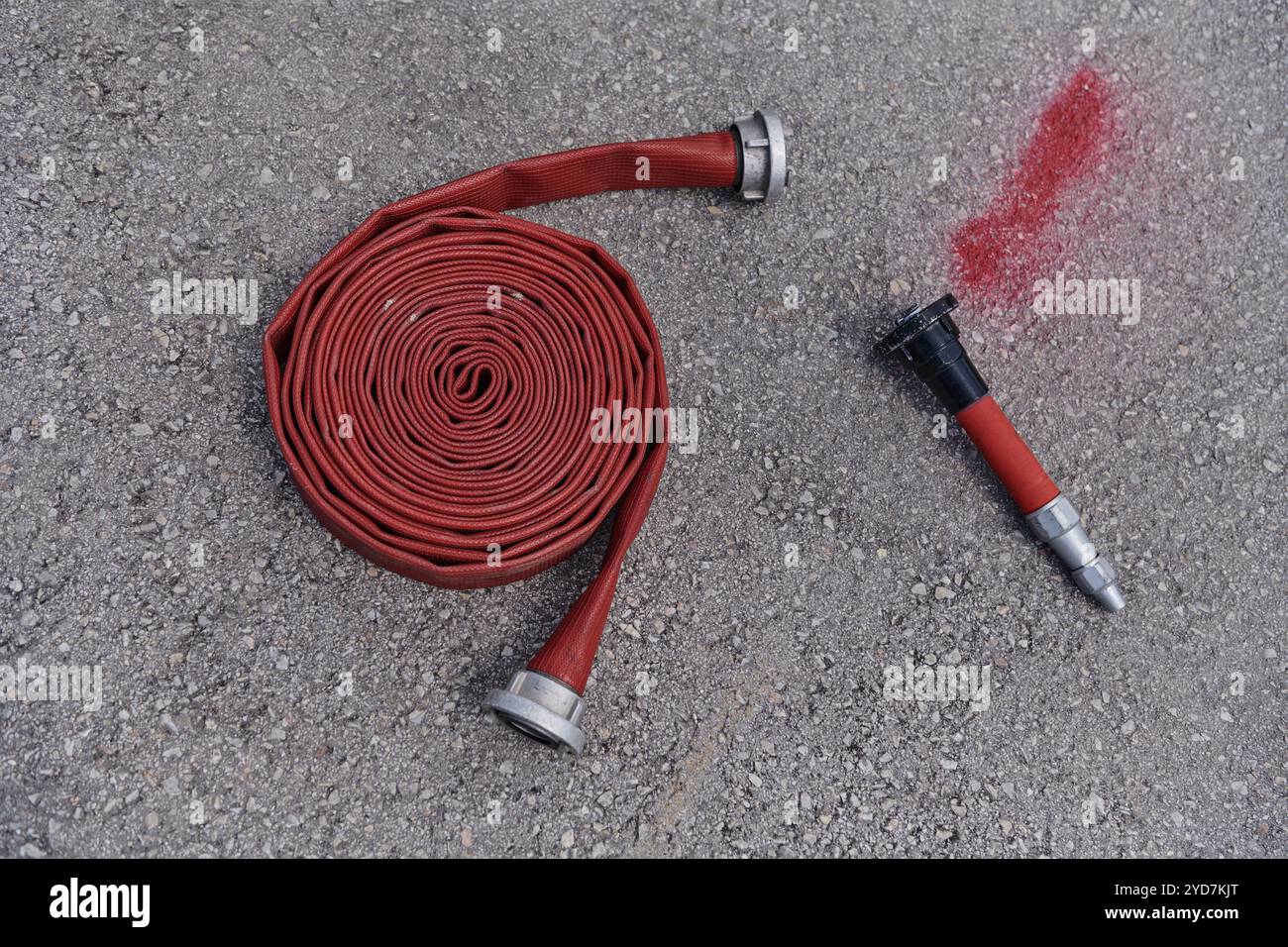 Coiled Fire Hose Ready for Action on the Ground Stock Photo - Alamy