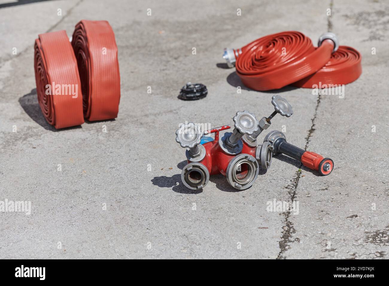 Coiled Fire Hose Ready for Action on the Ground Stock Photo - Alamy