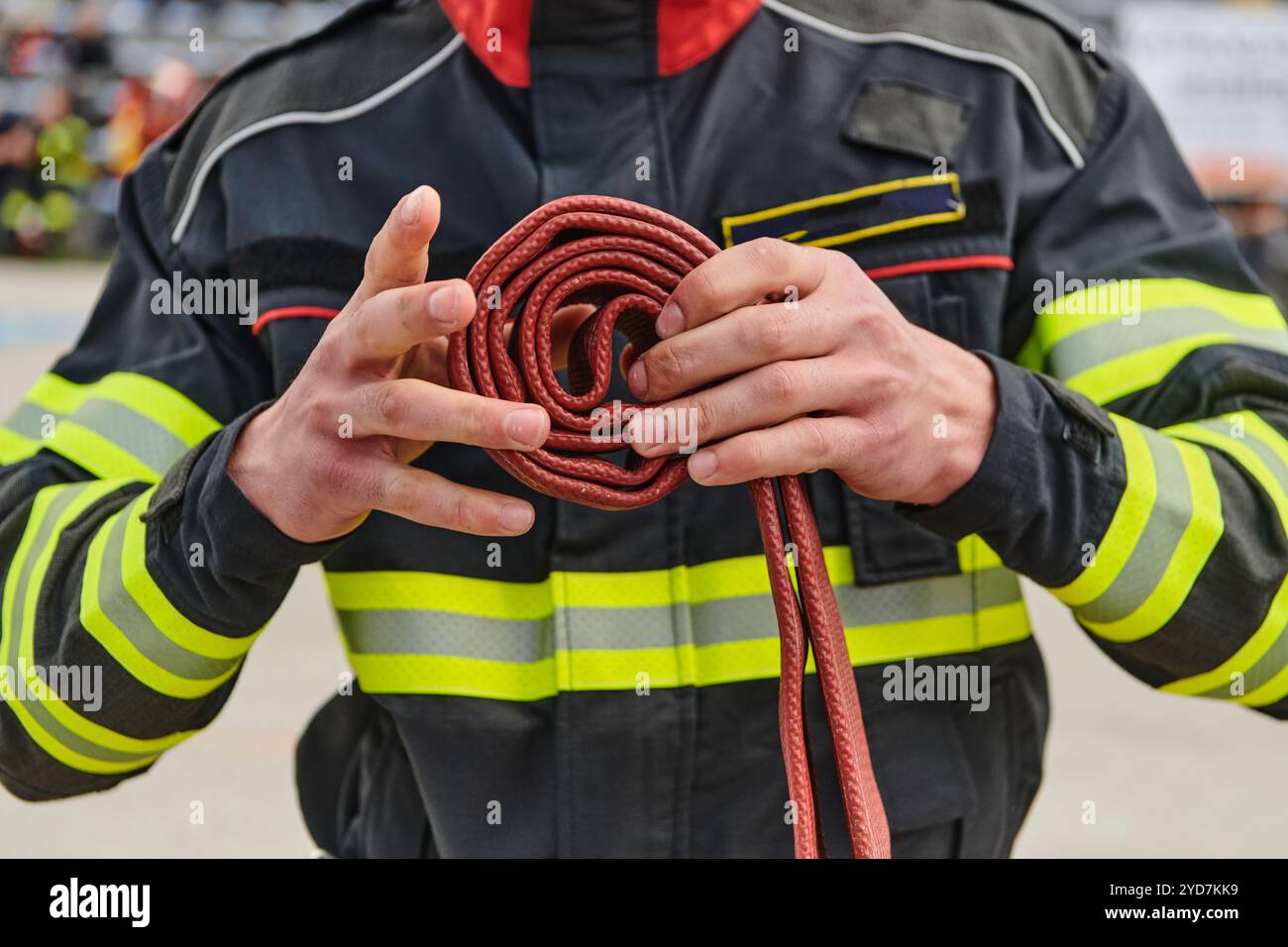 Professional Firefighter Cleaning Up Fire Hose After Extinguishing ...