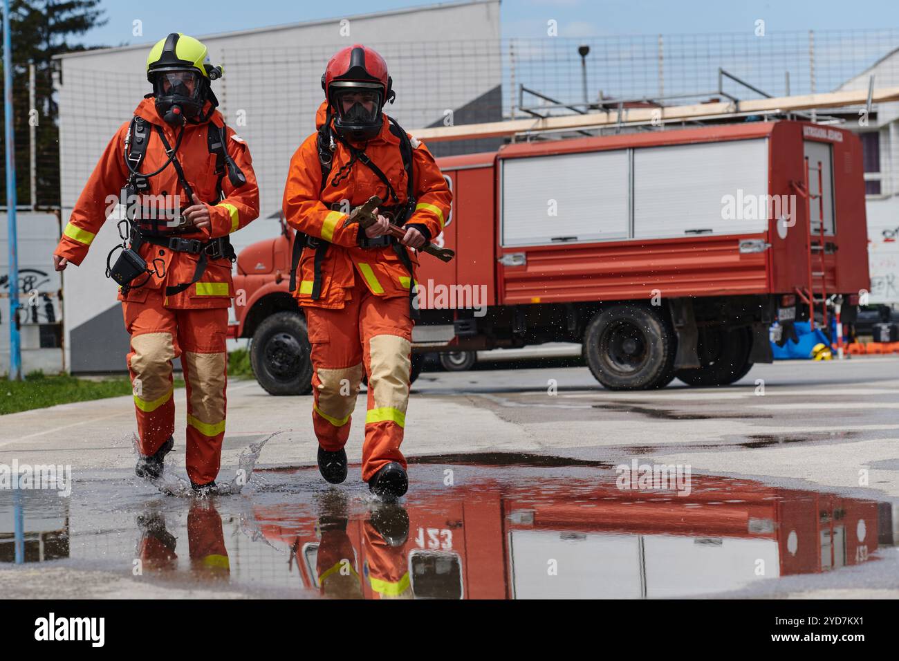 A team of firefighters, dressed in professional gear, undergoes ...