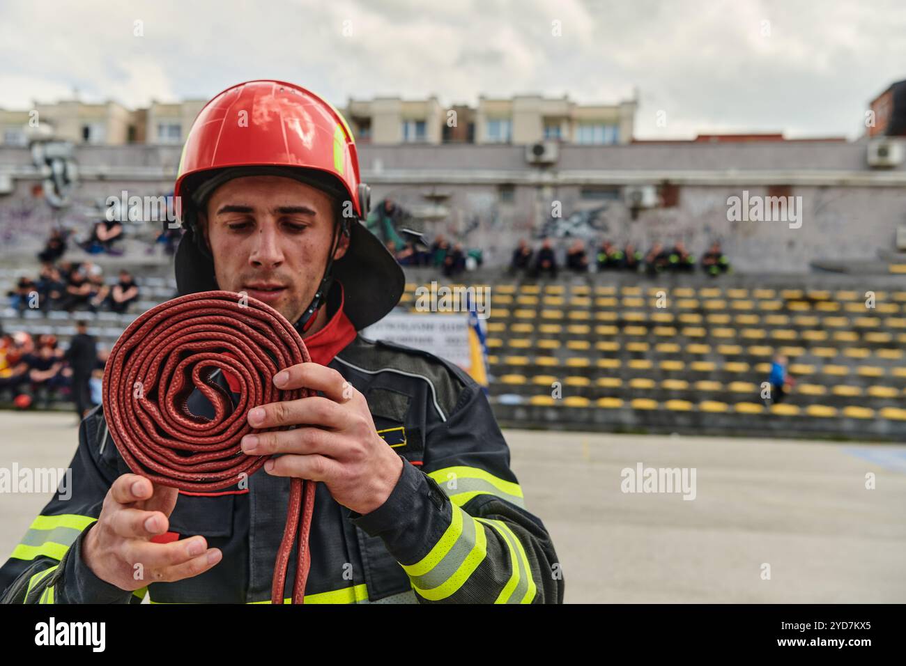 Professional Firefighter Cleaning Up Fire Hose After Extinguishing ...