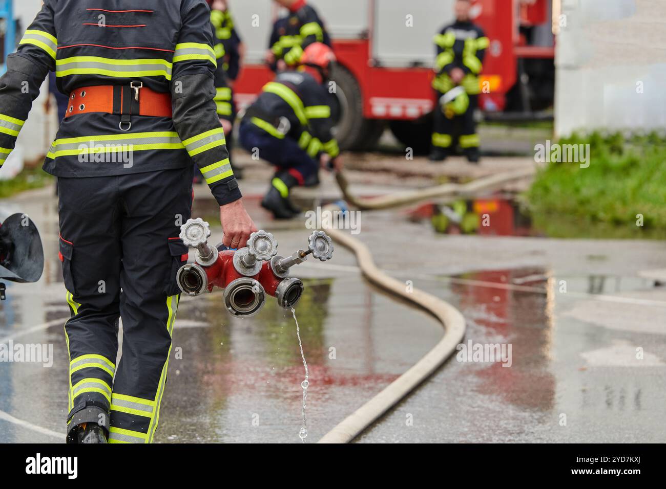 In a dynamic display of synchronized teamwork, firefighters hustle to ...