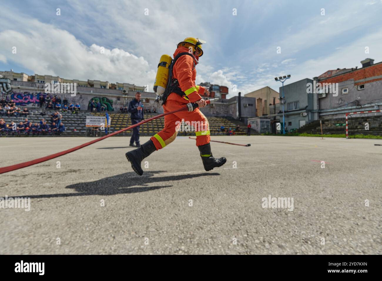 In a dynamic display of synchronized teamwork, firefighters hustle to ...