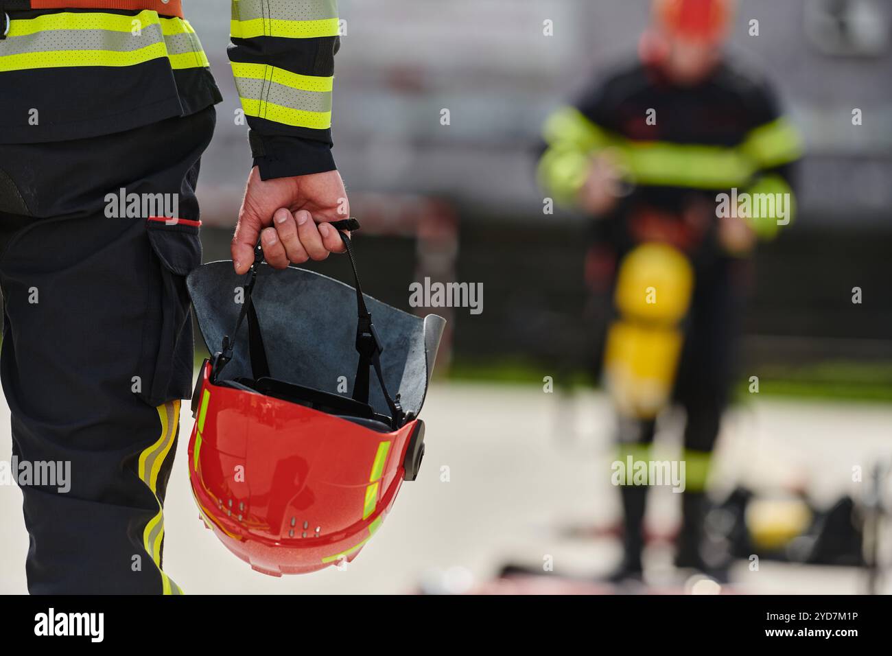 A close up shot capturing the hand of a firefighter holding a fire ...