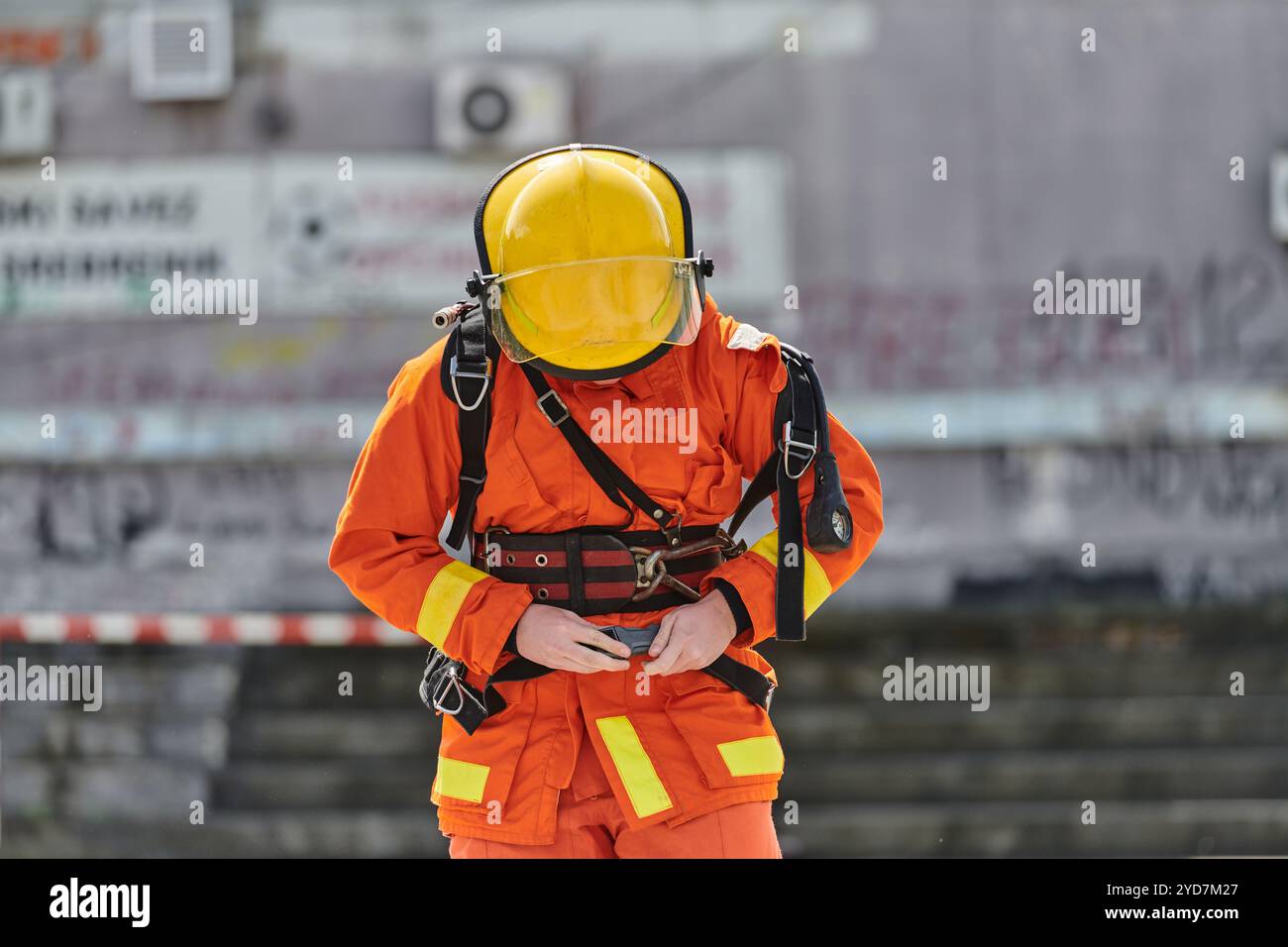 A firefighter dons the essential components of their professional gear ...