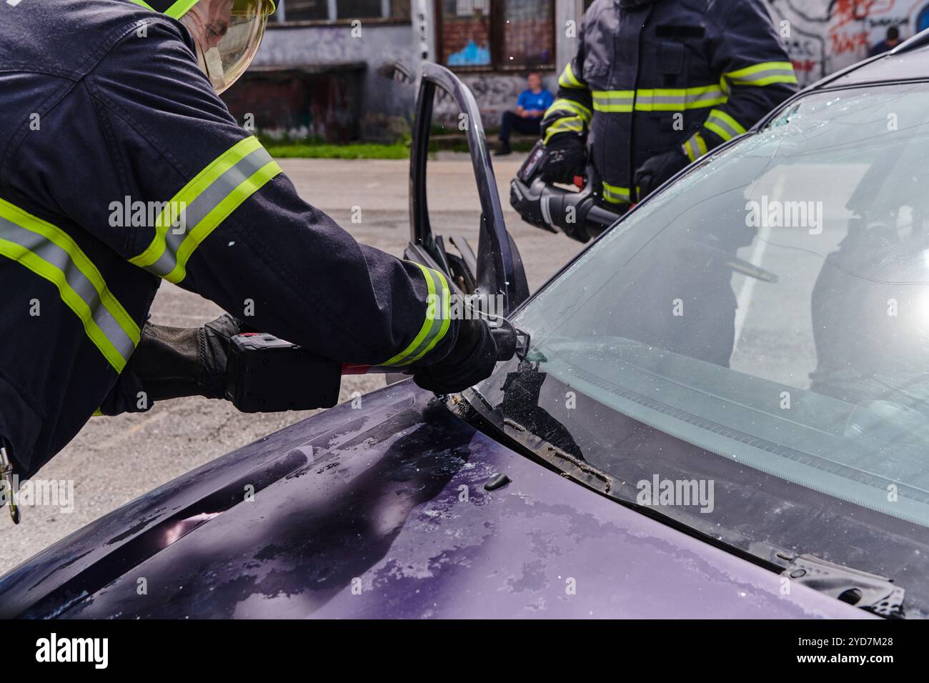 A dedicated team of professional firefighters employs specialized tools ...