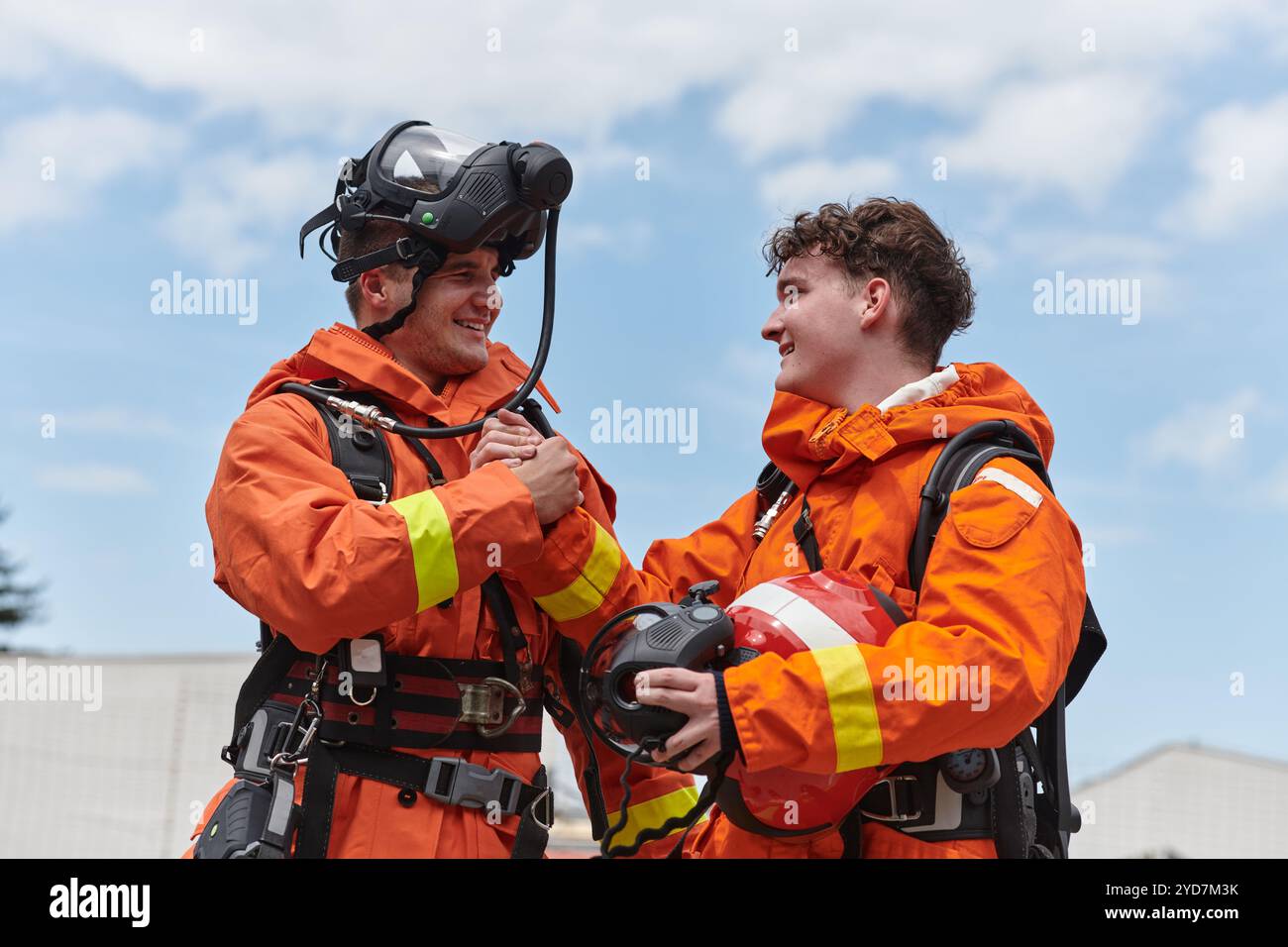 A unified team of firefighters, adorned in their uniforms, engages in a ...
