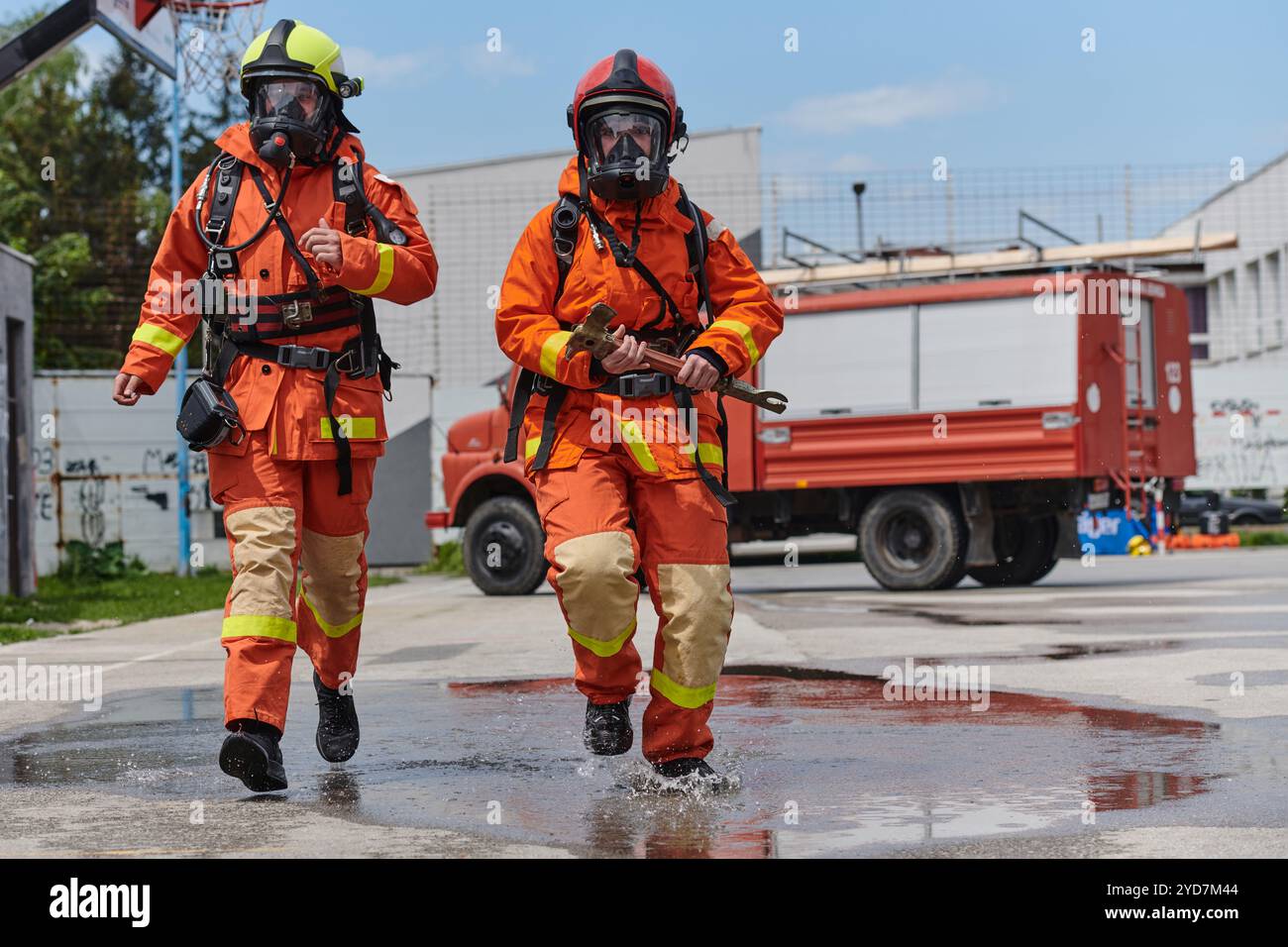 A team of firefighters, dressed in professional gear, undergoes ...