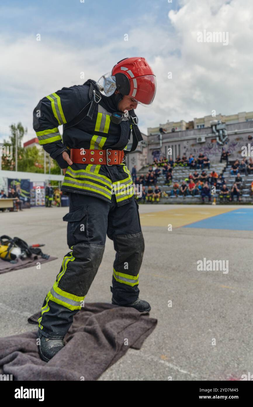A firefighter dons the essential components of their professional gear ...