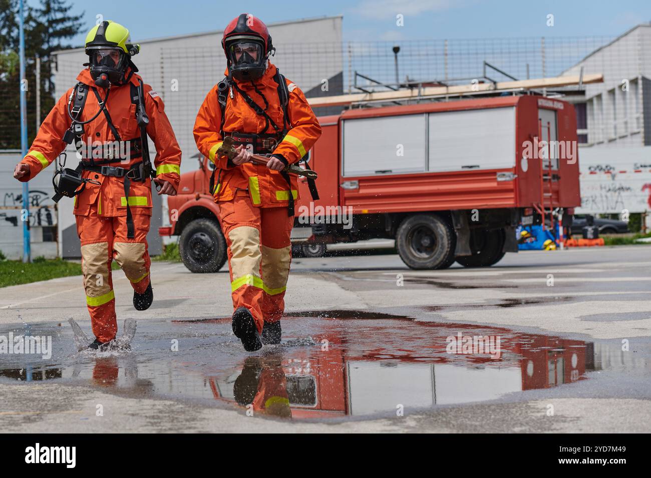 Firefighter Team Training with Various Tools in Professional Gear Stock ...