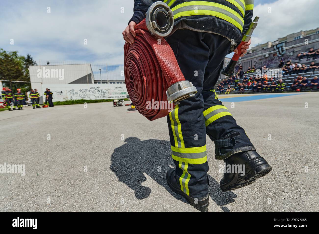 In a dynamic display of synchronized teamwork, firefighters hustle to ...