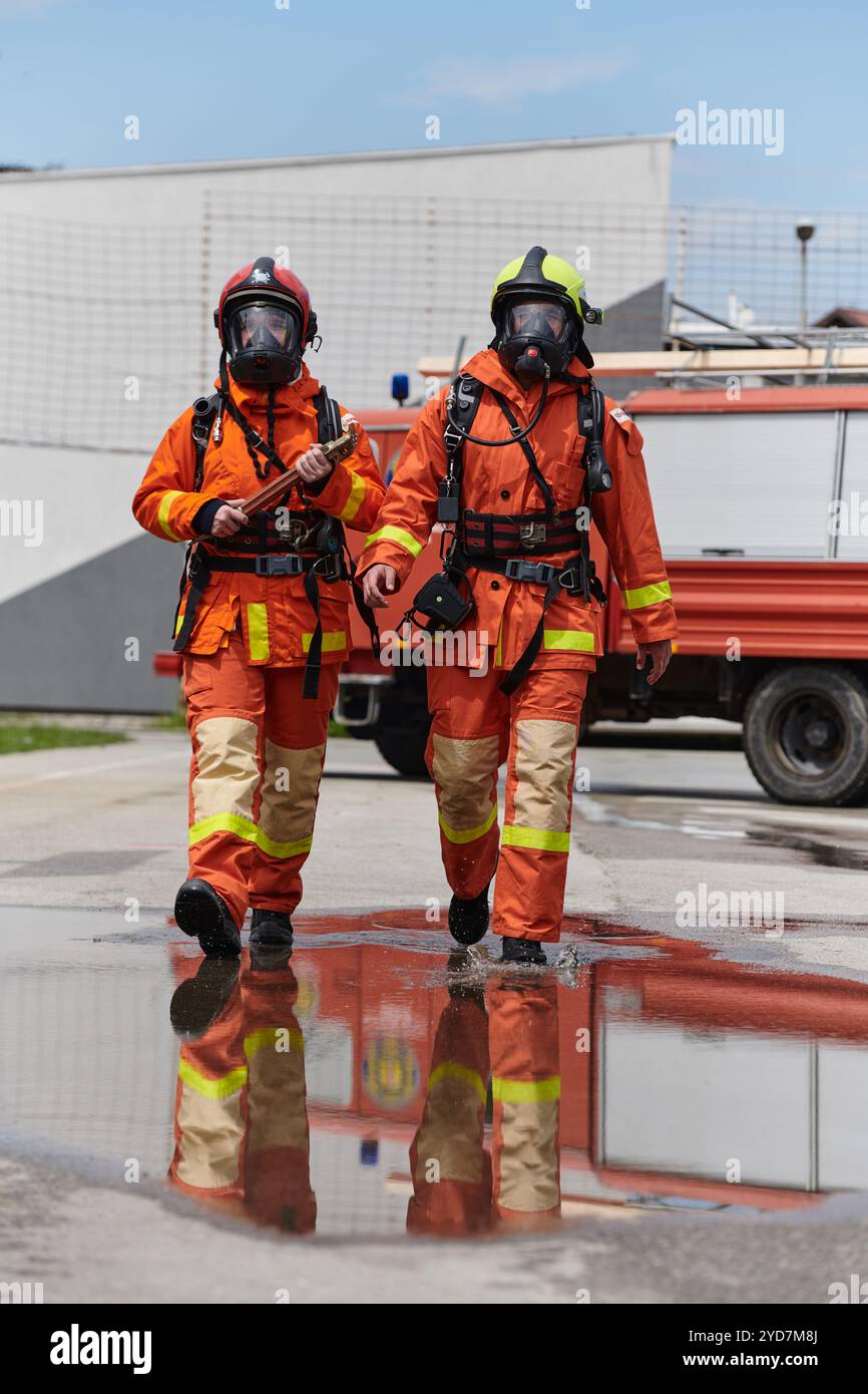 A team of confident and accomplished firefighters strides purposefully ...
