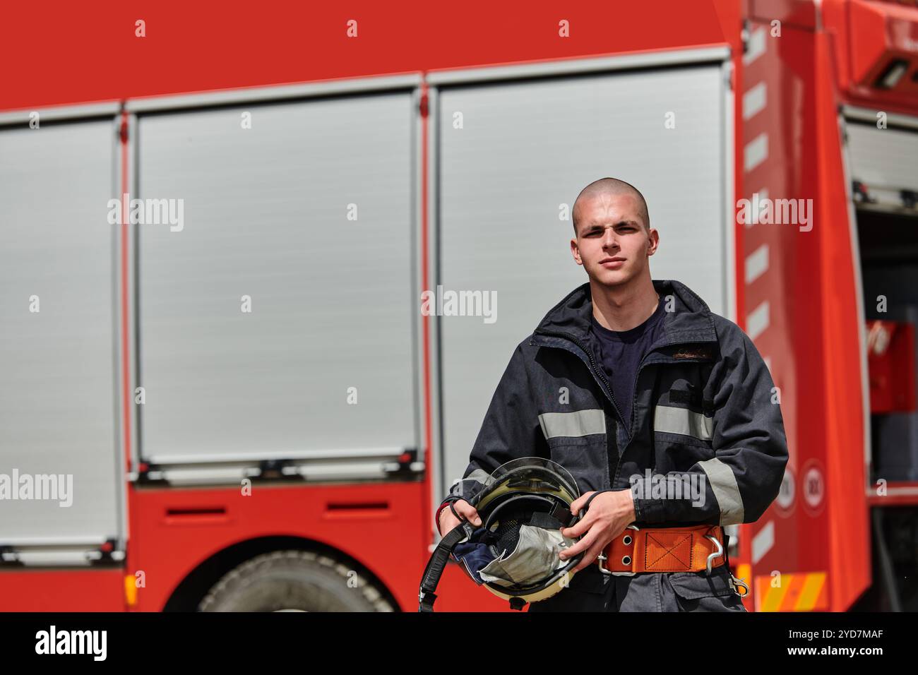 Firefighter Stands Proudly with Professional Gear Beside Fire Truck ...
