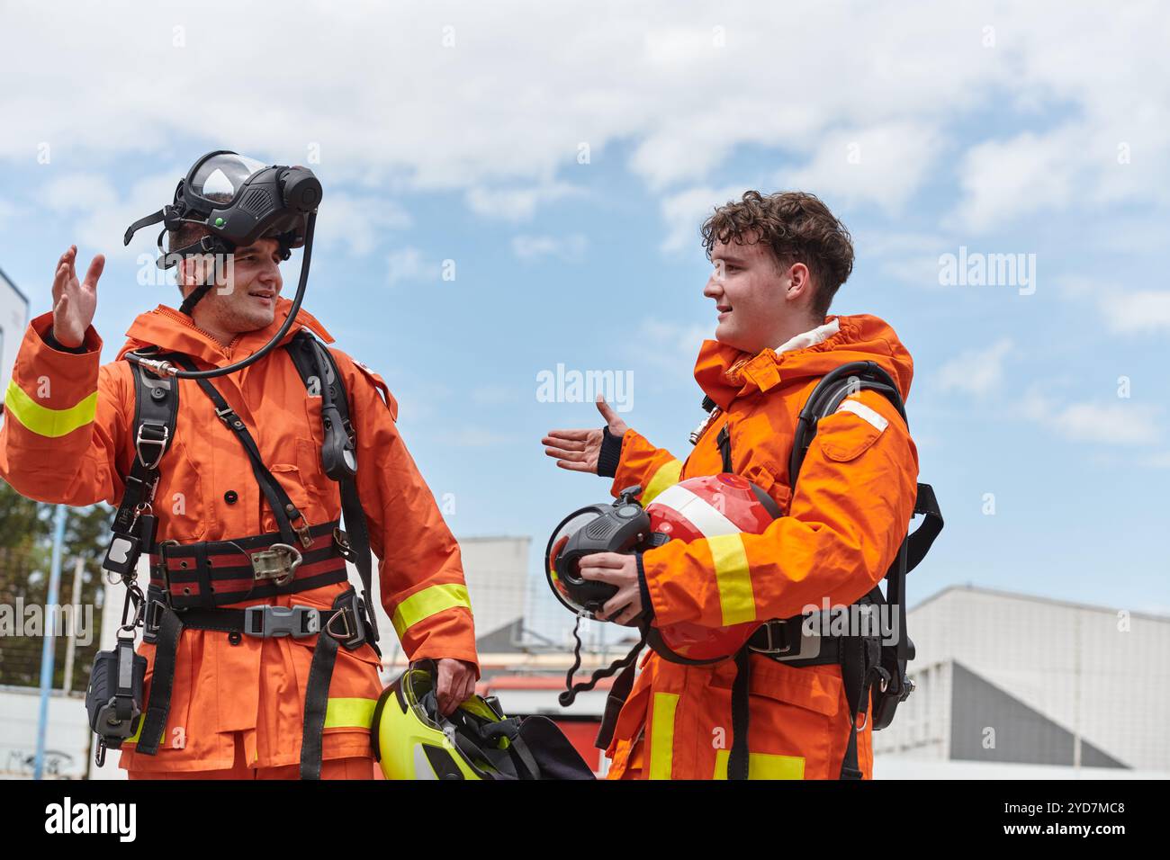 A unified team of firefighters, adorned in their uniforms, engages in a ...