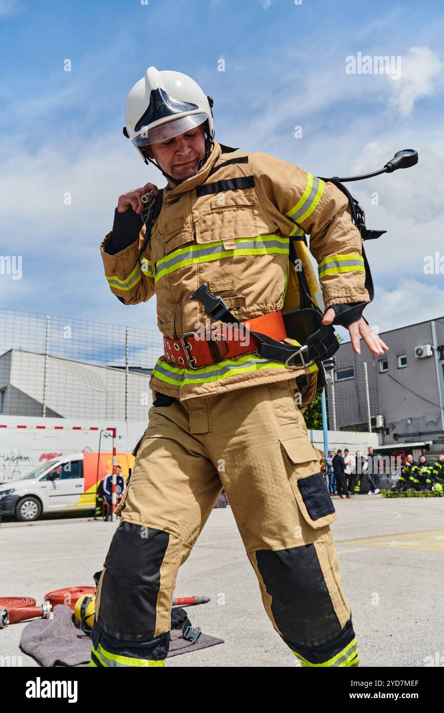 A firefighter dons the essential components of their professional gear ...