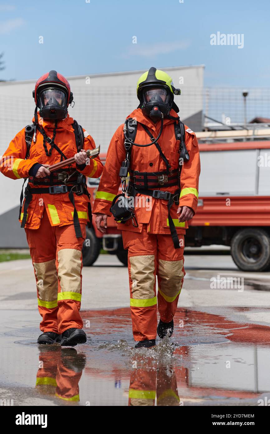 A team of confident and accomplished firefighters strides purposefully ...
